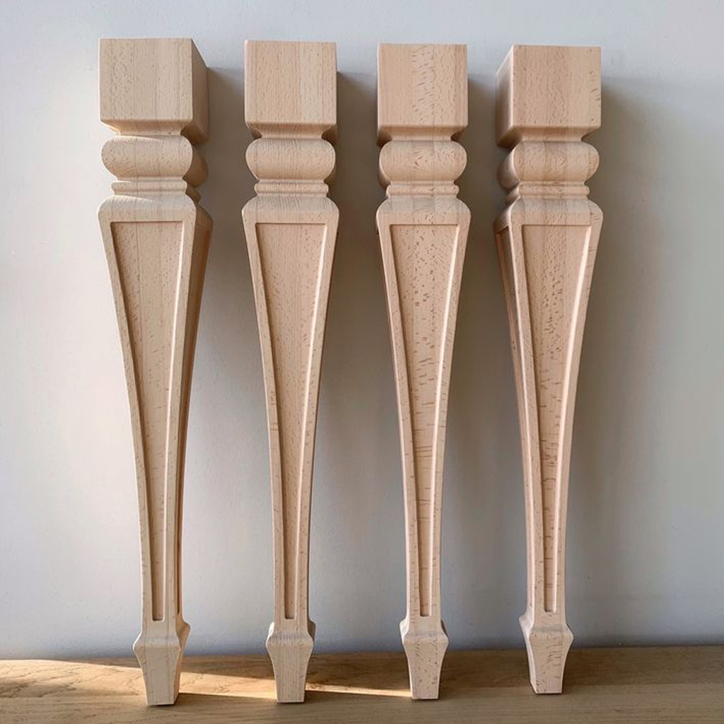 Square top tapered table legs with carved elements and spade foot